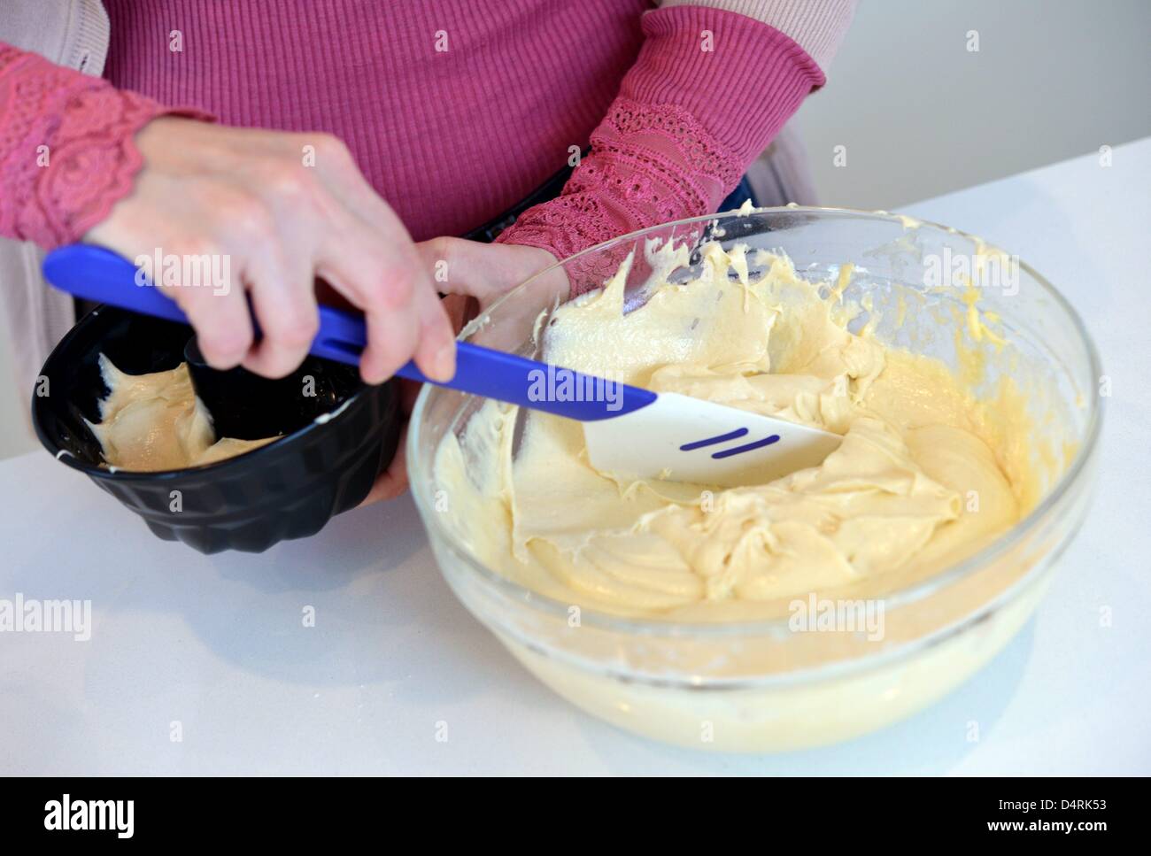 Preparing a cake in a kitchen. Photo: Frank May Stock Photo - Alamy