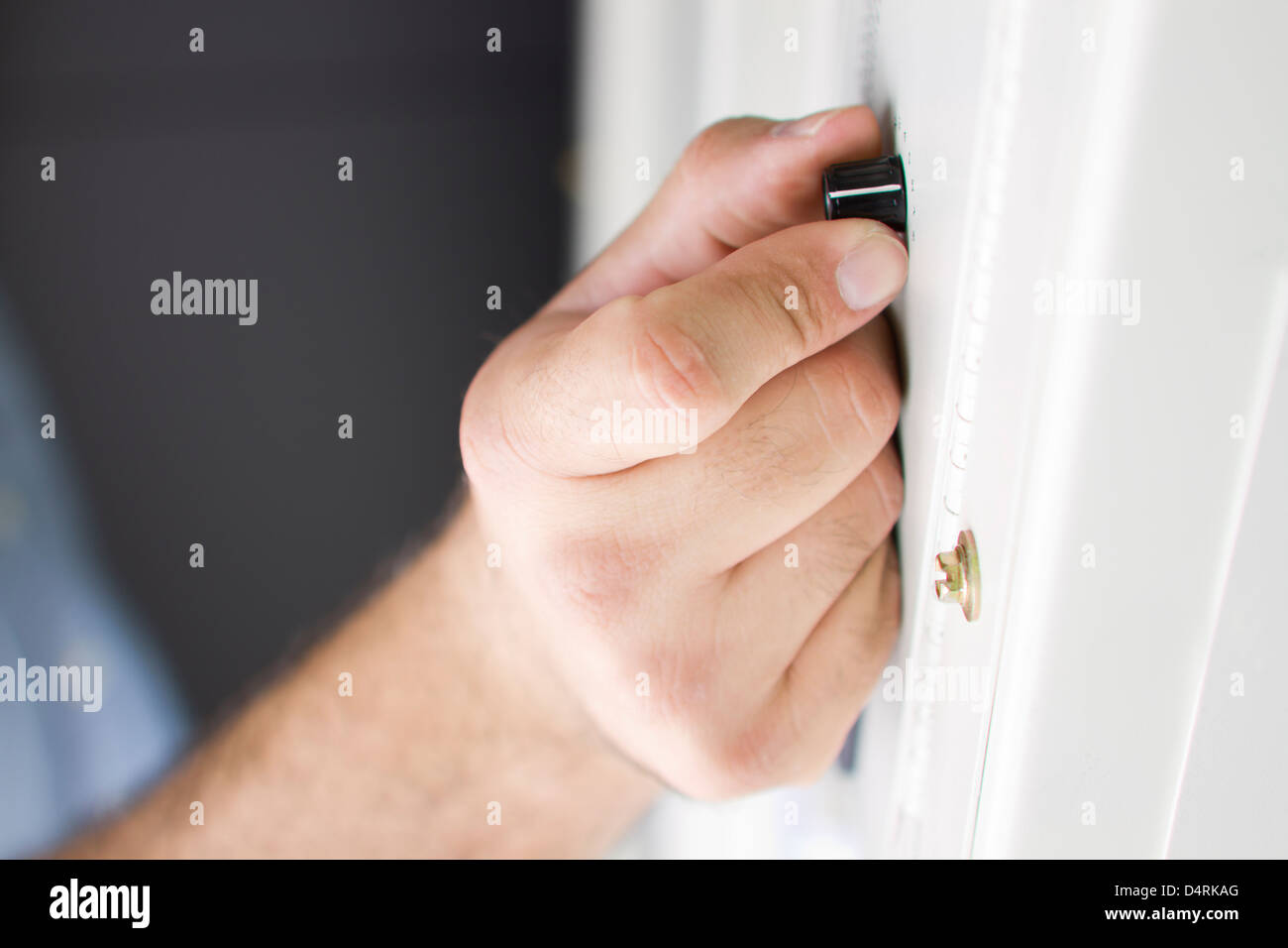 Clean close up right hand holding a dial knob and tuning Stock Photo ...
