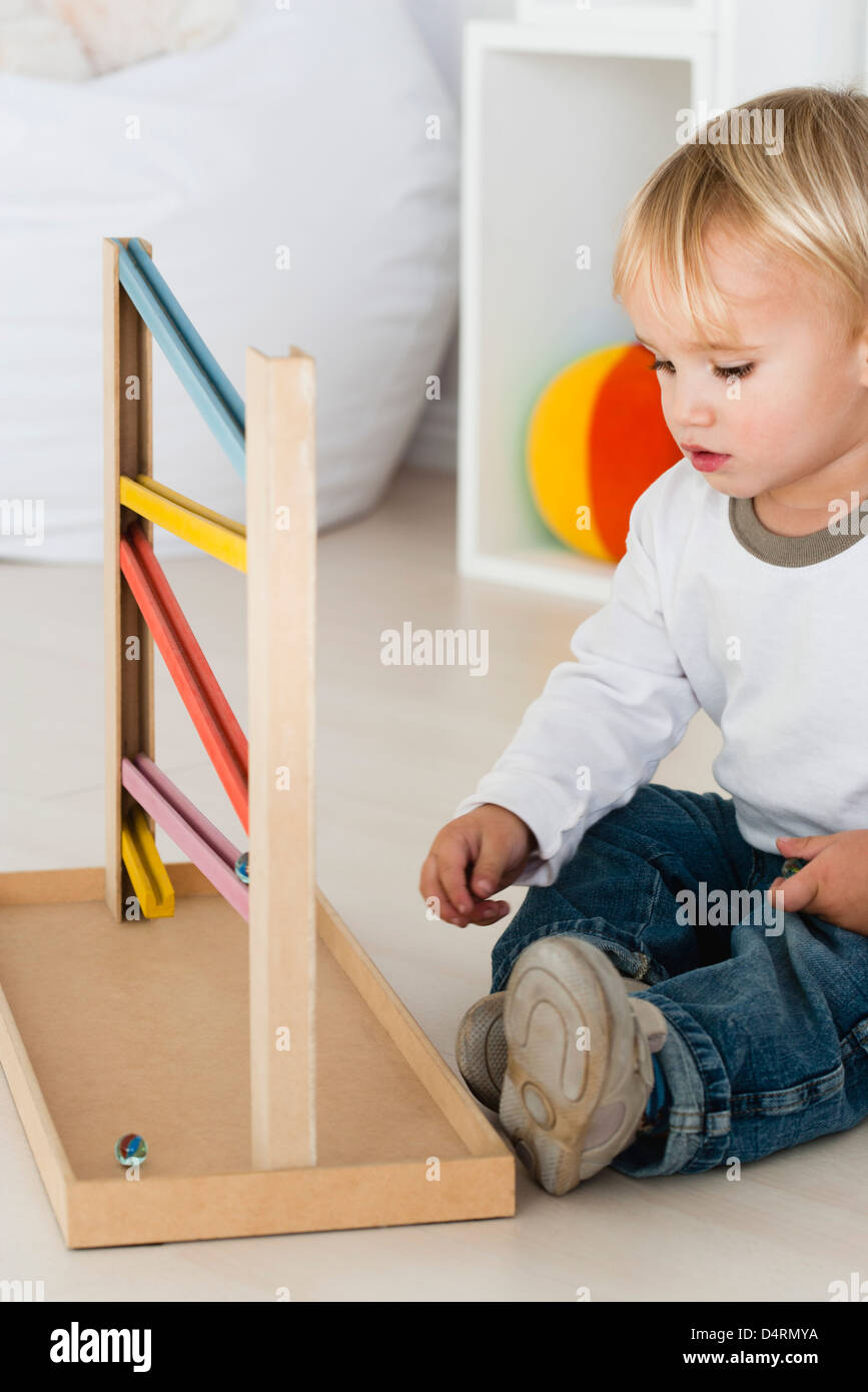 Baby playing with marble rolling game Stock Photo - Alamy
