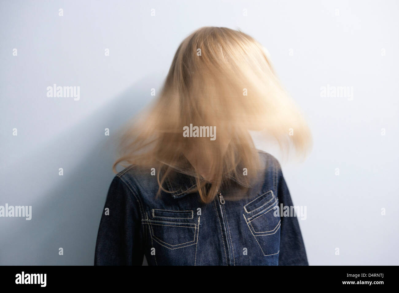 Young woman tossing her hair Stock Photo - Alamy