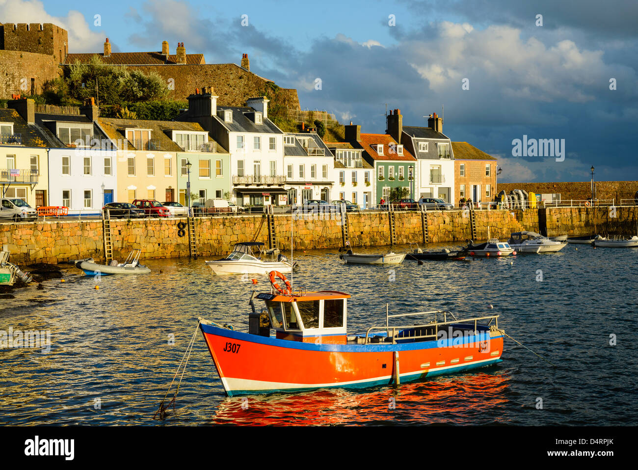 Mont Orgueil Castle rises above the harbour of Gorey on Jersey Stock ...