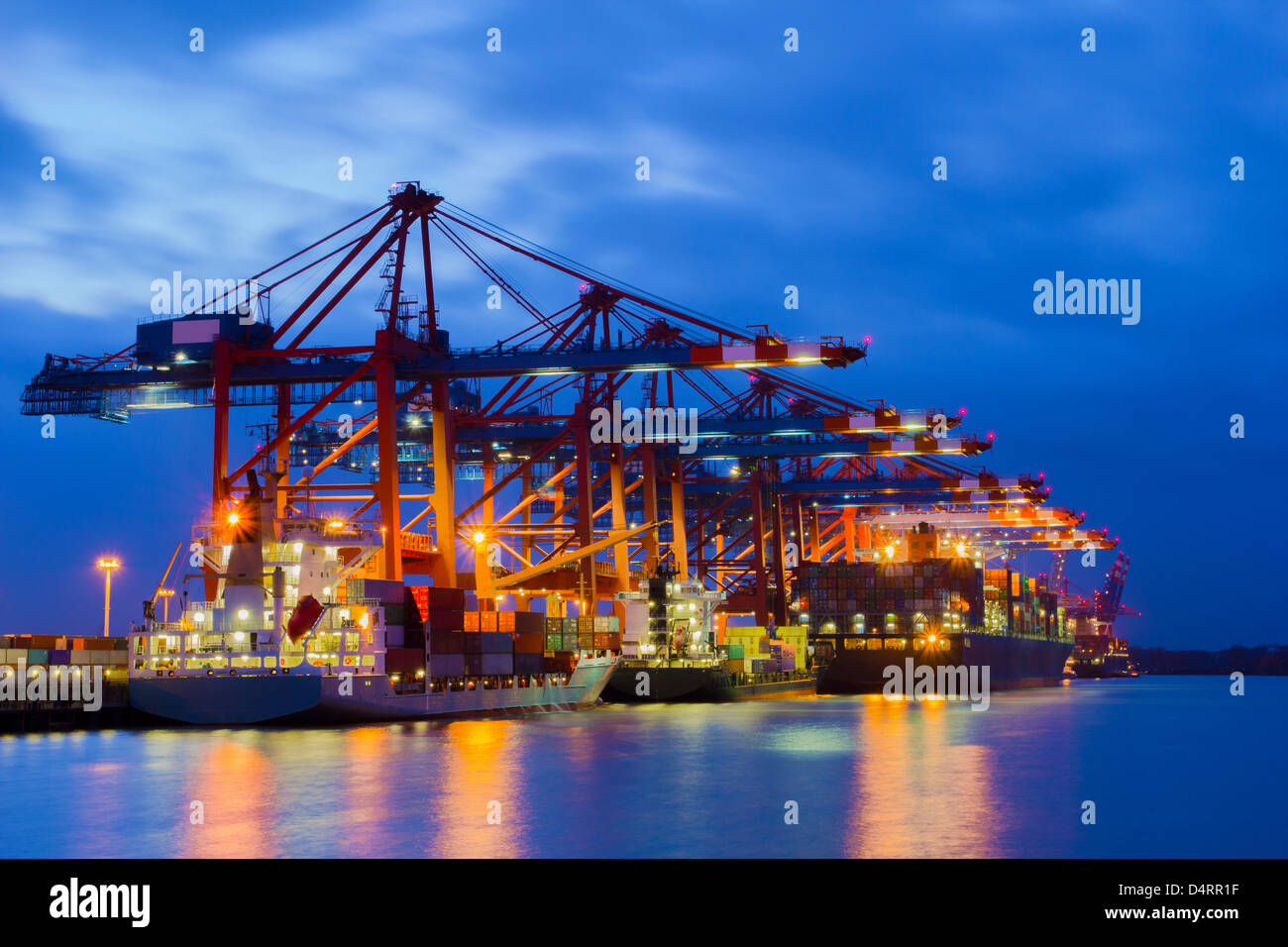 Container terminal with ships and cranes at twilight Stock Photo - Alamy