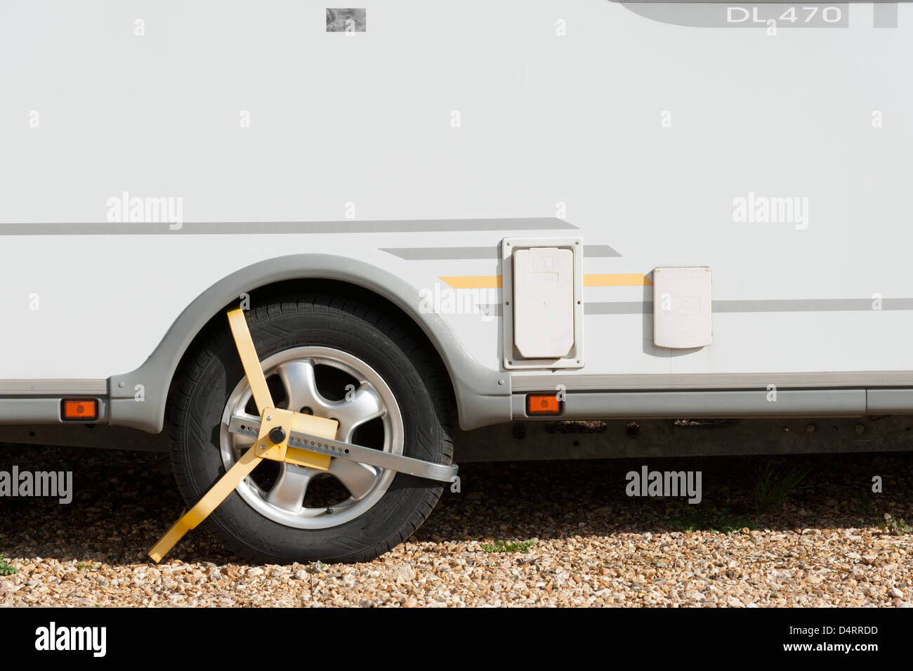 A wheel clamp or wheelclamp or lock on a caravan wheel Stock Photo - Alamy