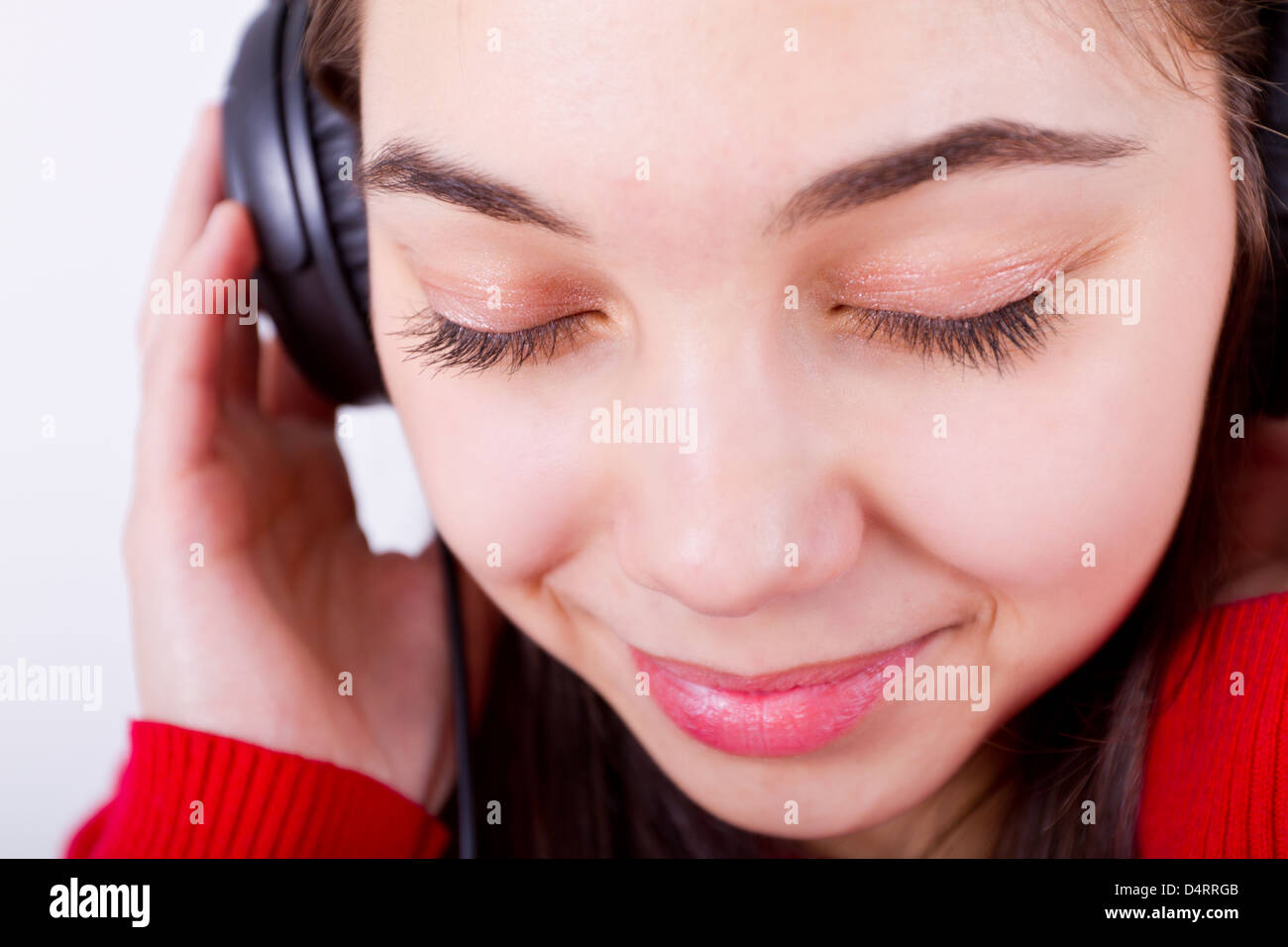 Young girl listening/feeling music her eyes shut. Perhaps classical ...