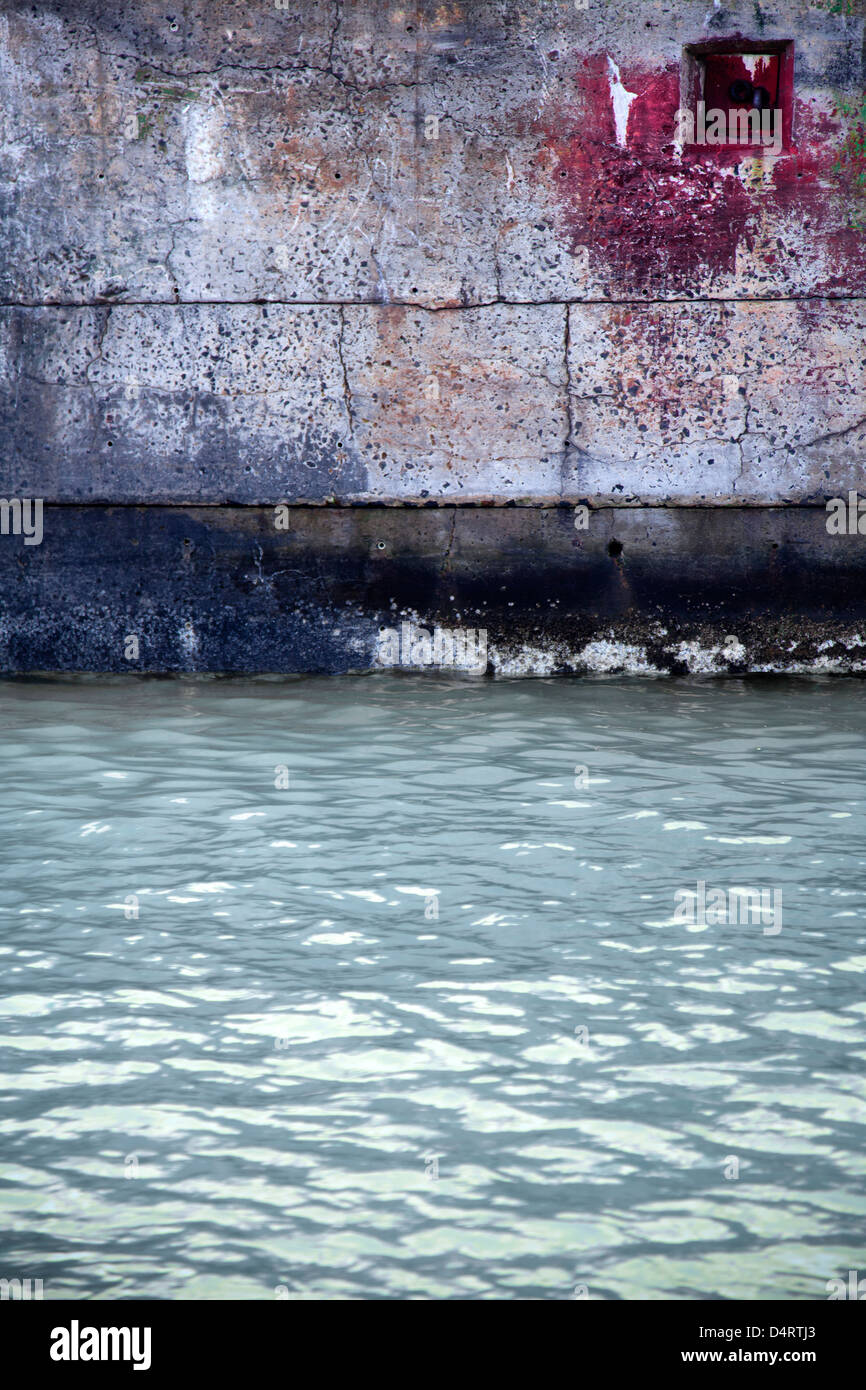 Murky Jetty wall With Red Square Stock Photo - Alamy