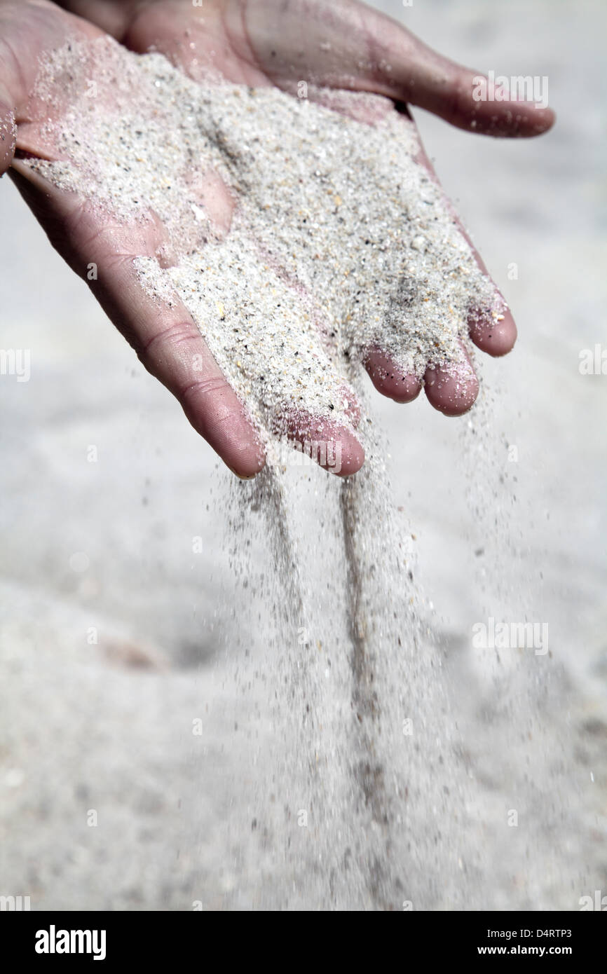 Sand slipping through fingers hand hi-res stock photography and images ...