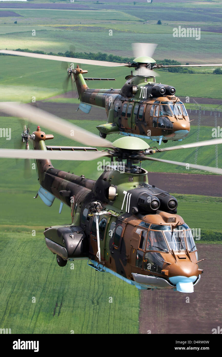 Pair of Eurocopter AS-532 AL Cougar helicopters in flight over Bulgaria ...