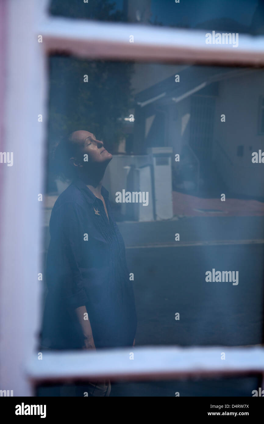 Woman Reflected in Window Panes Stock Photo - Alamy