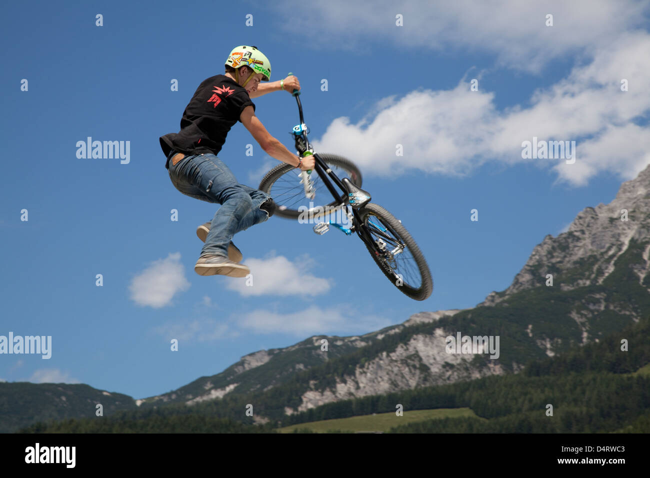 Stunt biker doing jump trick in the air Stock Photo - Alamy