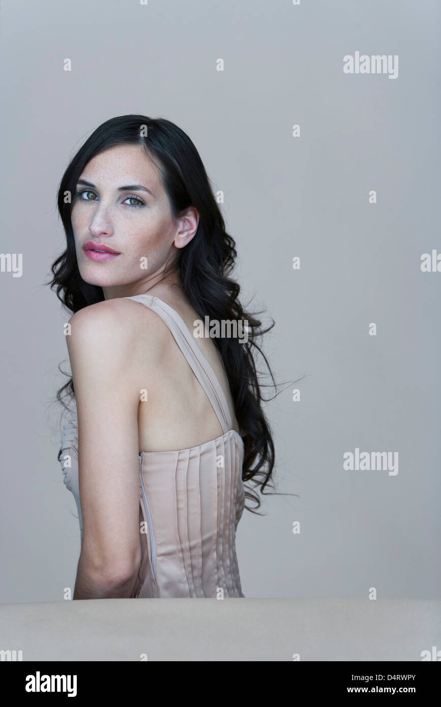 Young woman looking over shoulder, portrait Stock Photo - Alamy