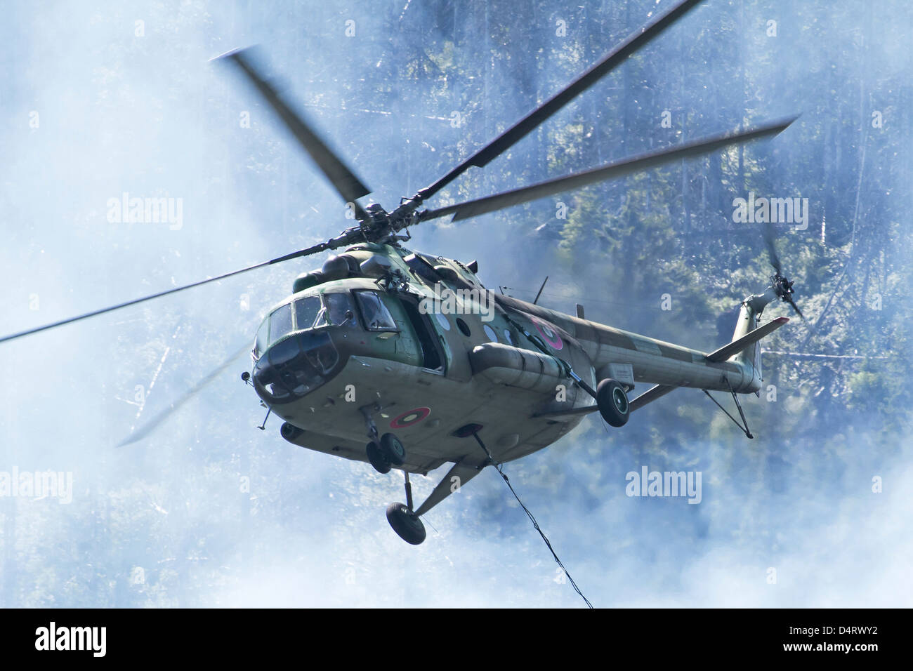 A Bulgarian Air Force Mi-17 helicopter with bambi bucket over a forest ...