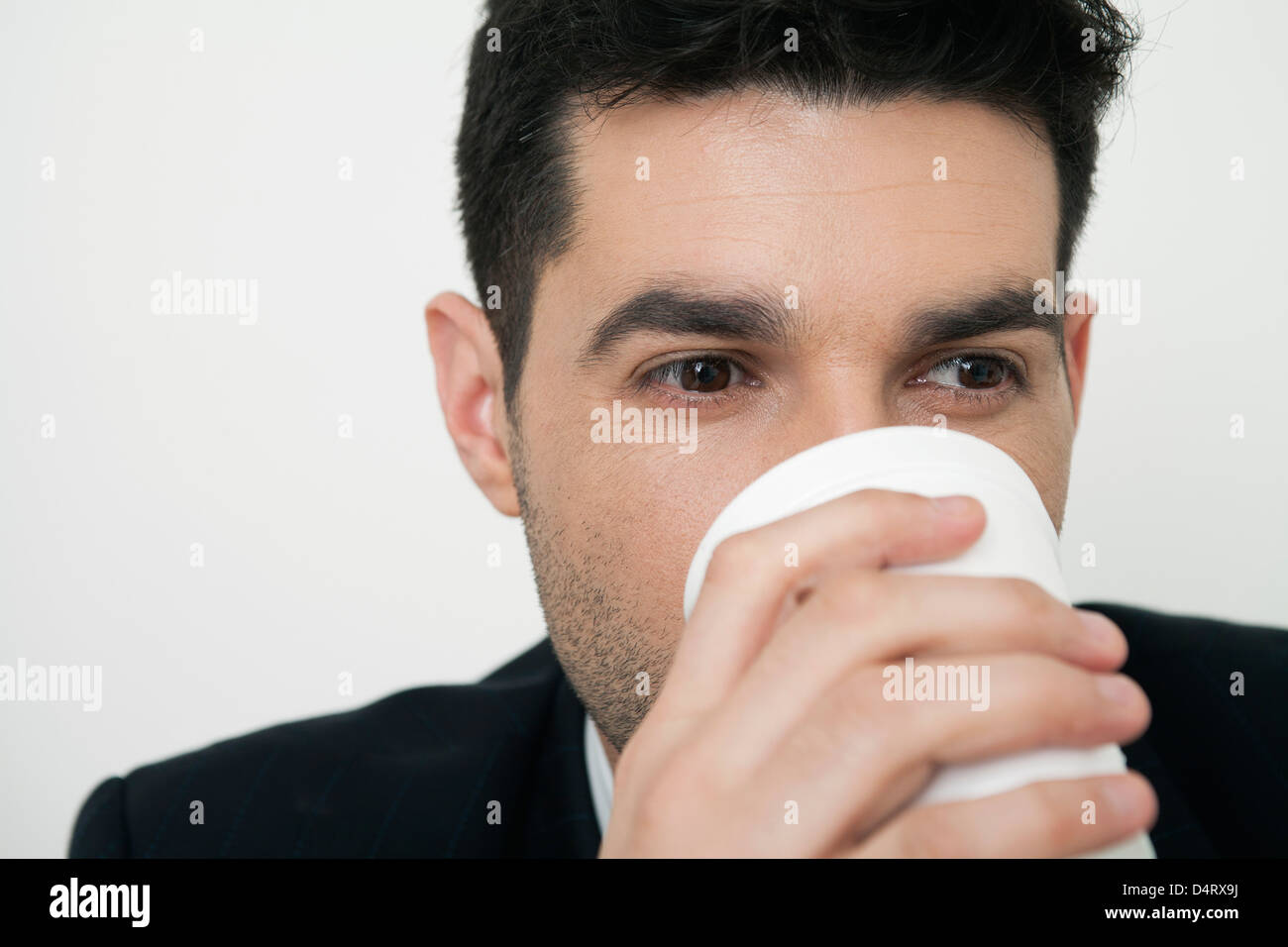 Man drinking from cup Stock Photo - Alamy