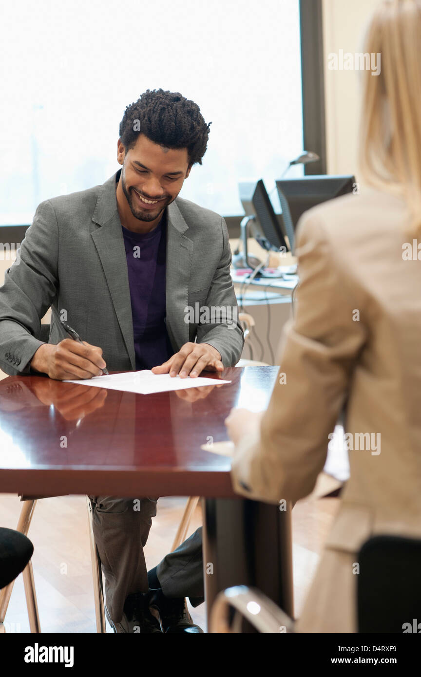 Professional man completing application at job interview Stock Photo ...