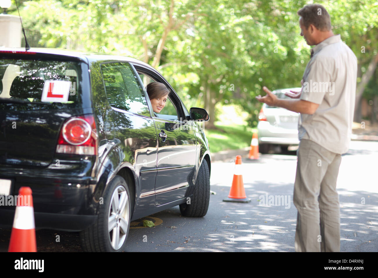 Father teaching teenage daughter driving Stock Photo - Alamy