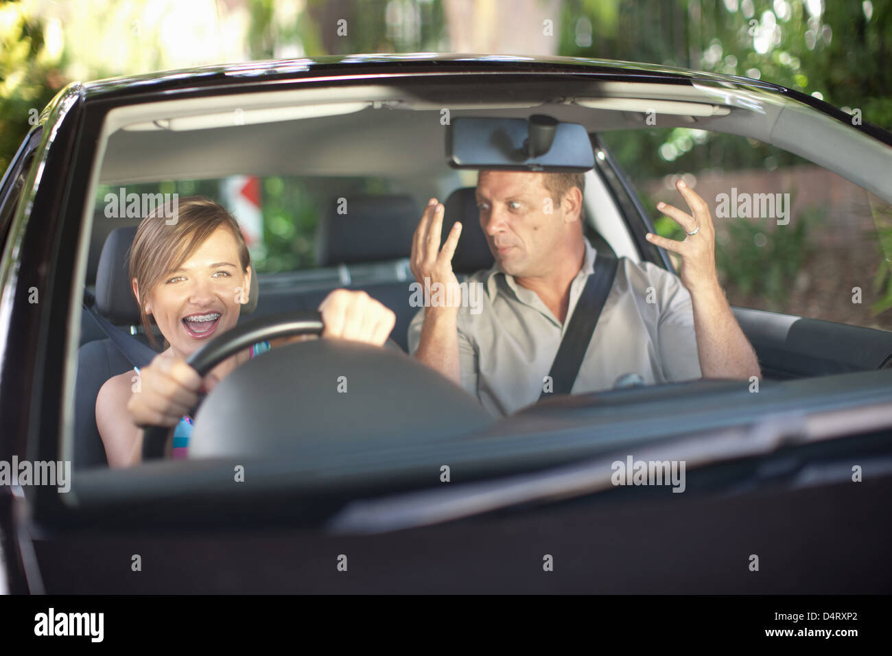 Father teaching teenage daughter driving Stock Photo - Alamy