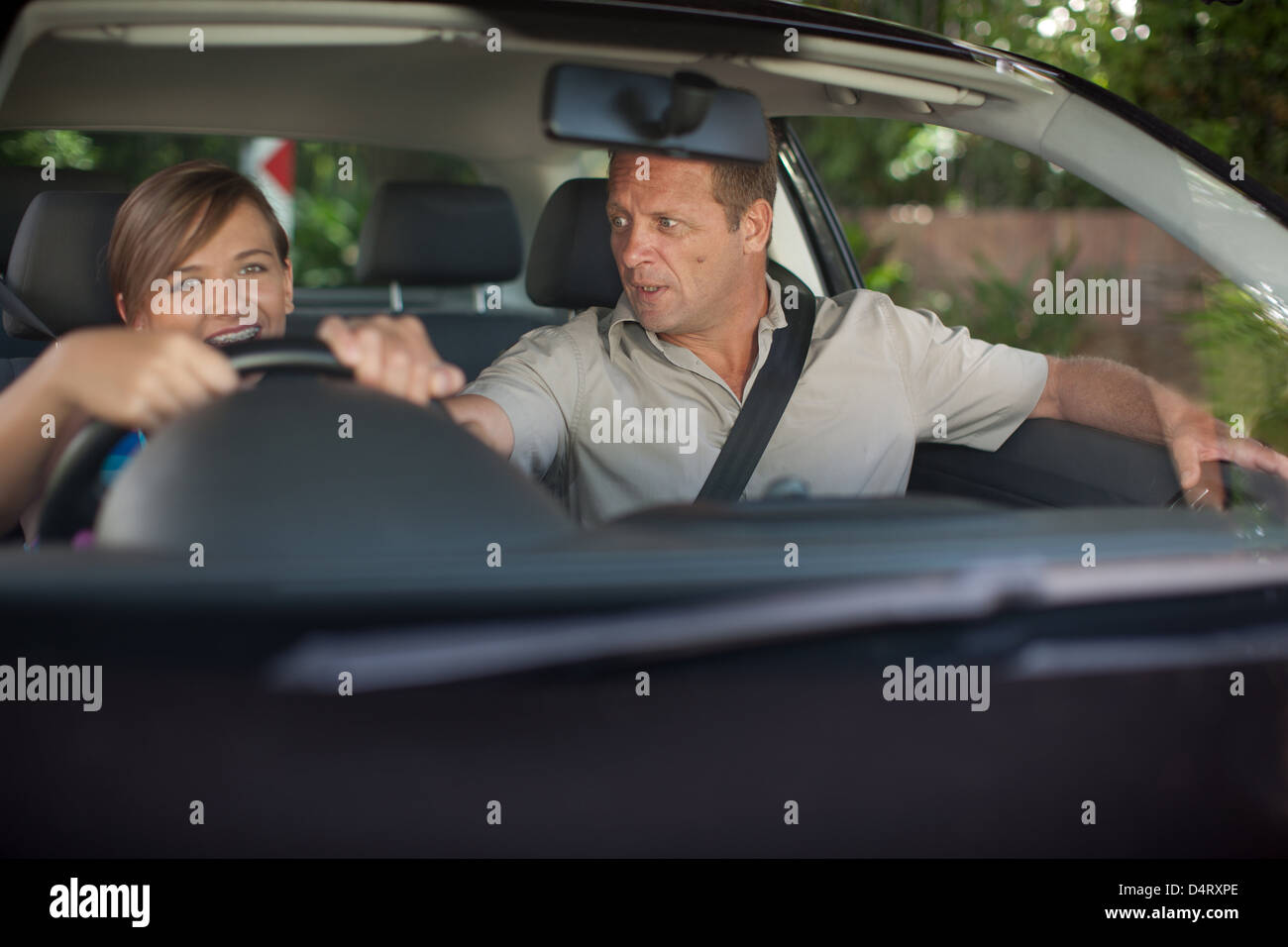 Father teaching teenage daughter driving Stock Photo - Alamy