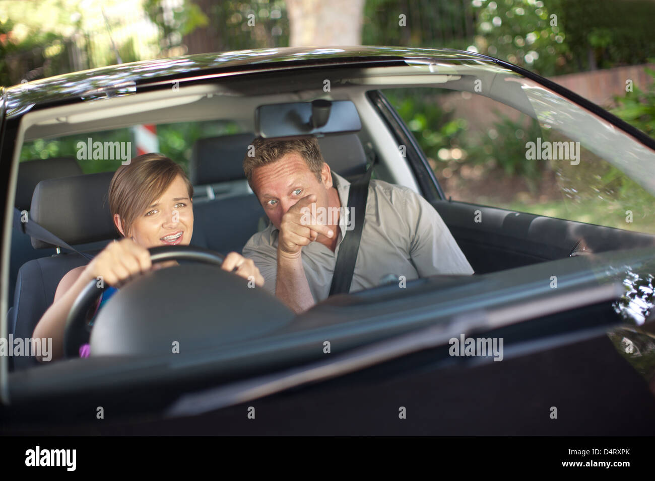 Father teaching teenage daughter driving Stock Photo - Alamy