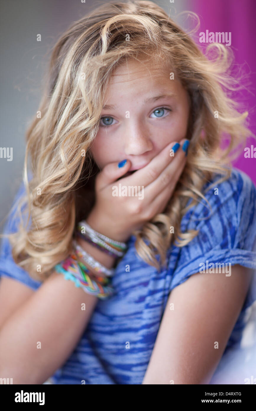 Girl gasping with hand over mouth Stock Photo - Alamy