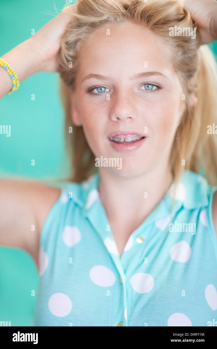 Teenage girl fixing her hair Stock Photo - Alamy