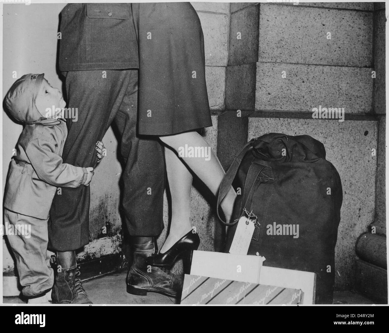 This World War II photograph captures a touching family moment, with a ...