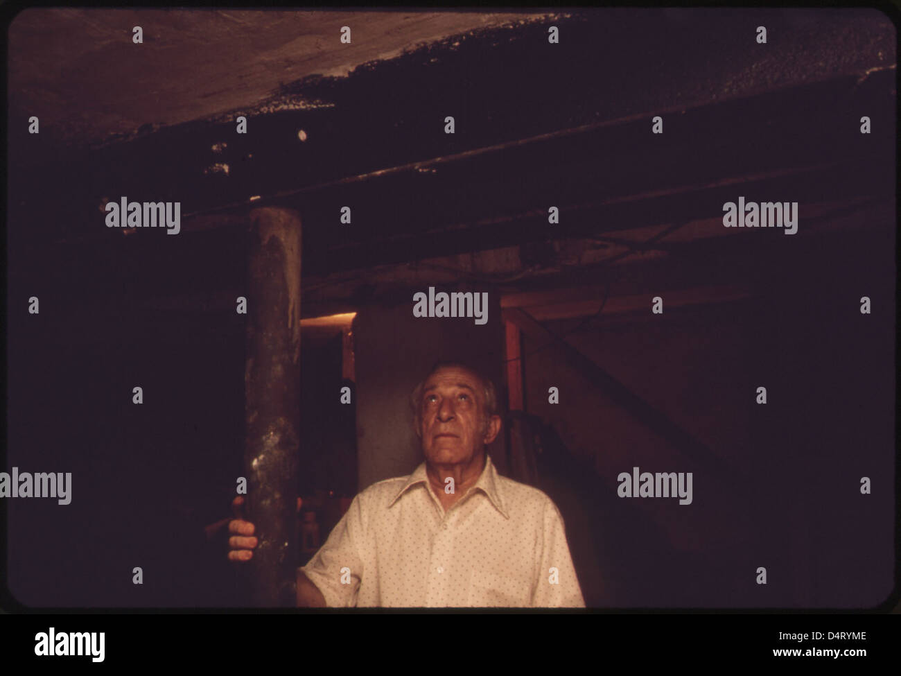 A photograph of Bernard Picarello touching a steel beam he installed in ...