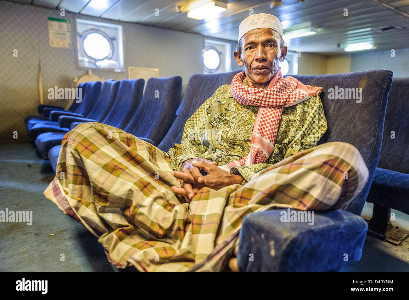 Muslim man travelling by ferry, Indonesia Stock Photo - Alamy
