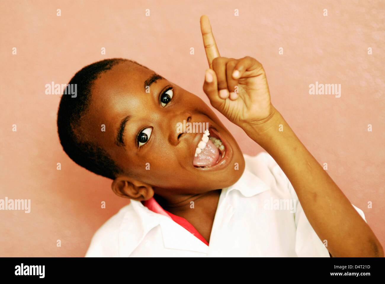 Africa, Angola, Luanda, portrait of a little African boy waving his ...