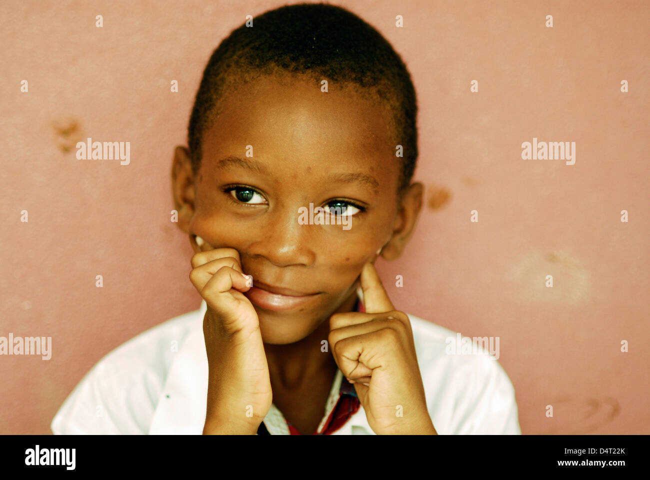 Africa, Angola, Luanda, close-up portrait of an African boy in a white ...
