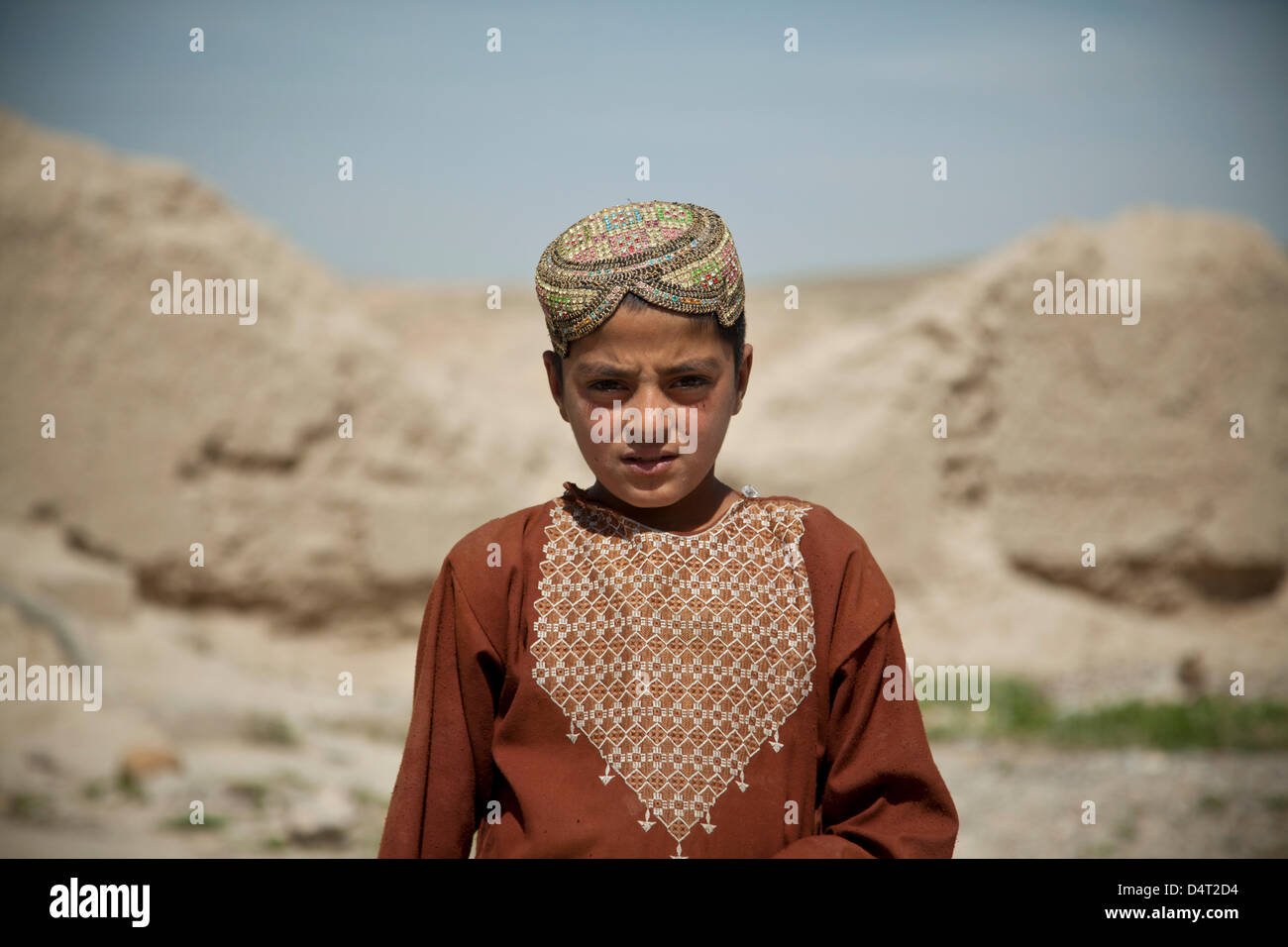 A young Afghan boy in traditional clothing watch US Special Forces and ...