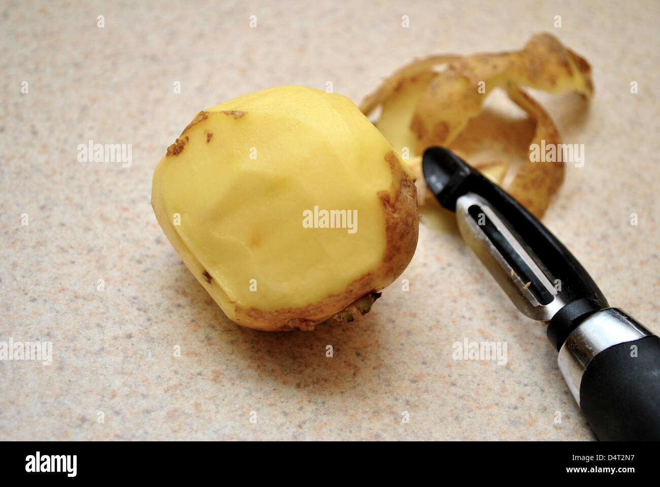 Peel raw potato vegetable peeler hi-res stock photography and images ...