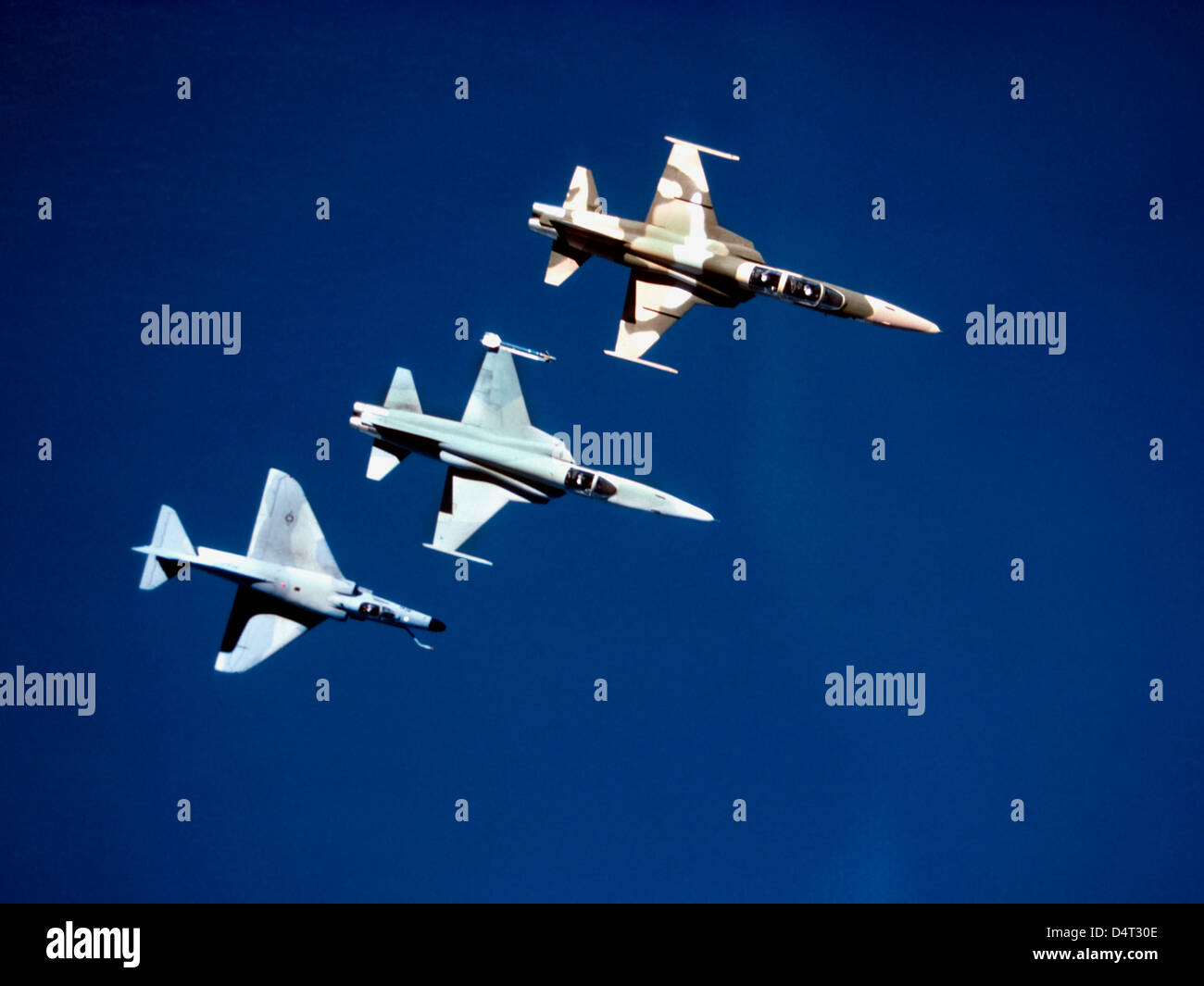 Two F-5 Tiger II's and an A-4E Skyhawk in flight above the Pacific ...