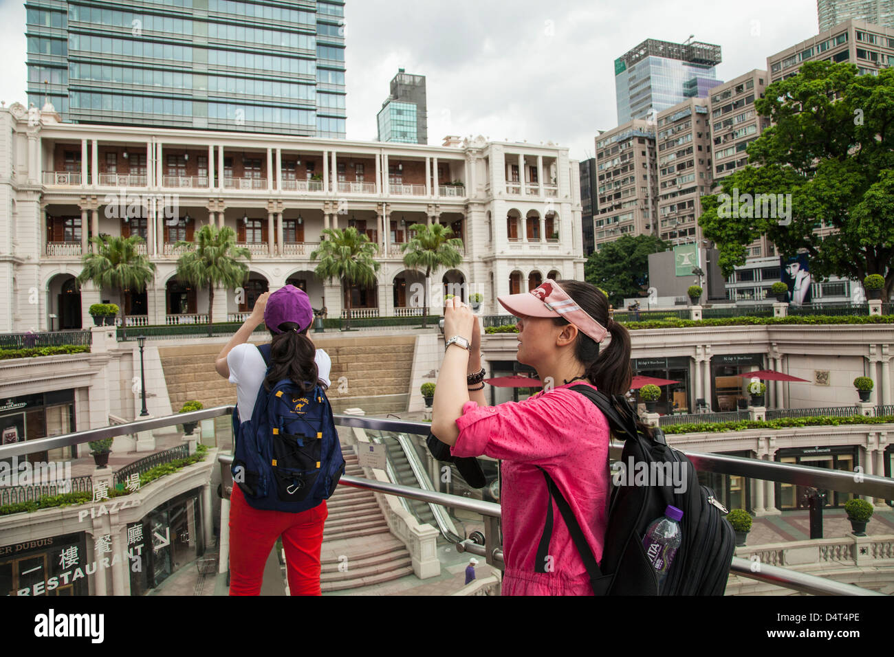 Young Asian women taking photographs with camera phones in a luxury ...
