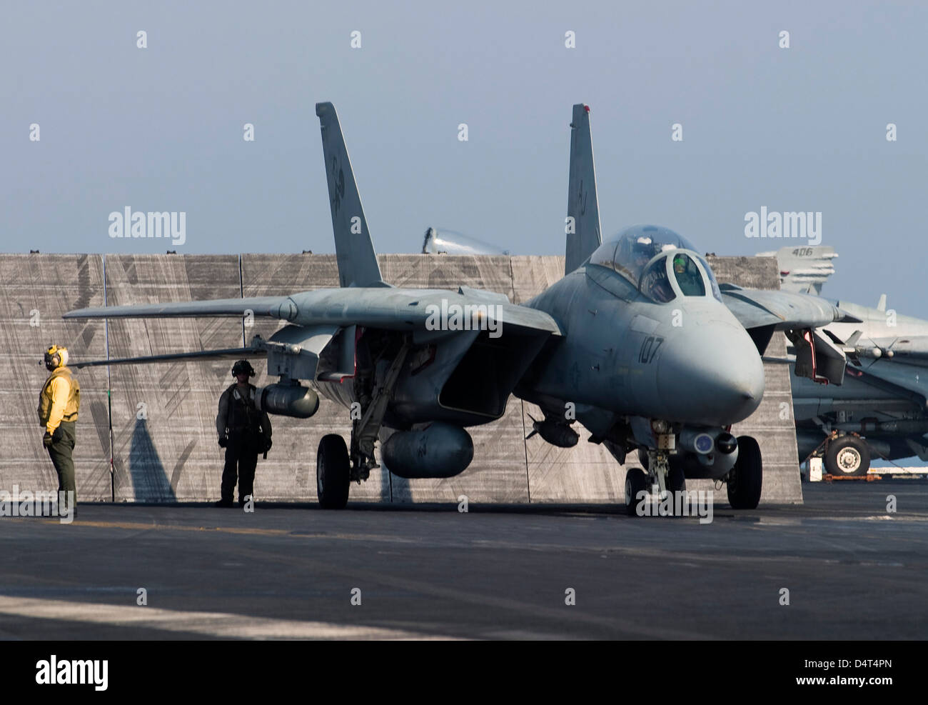 An F-14D Tomcat in launch position on the flight deck of USS Theodore ...