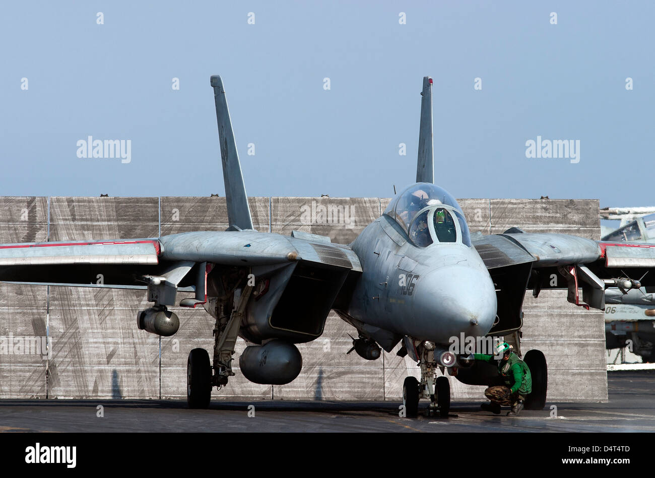 An F-14D Tomcat in launch position on the flight deck of USS Theodore ...