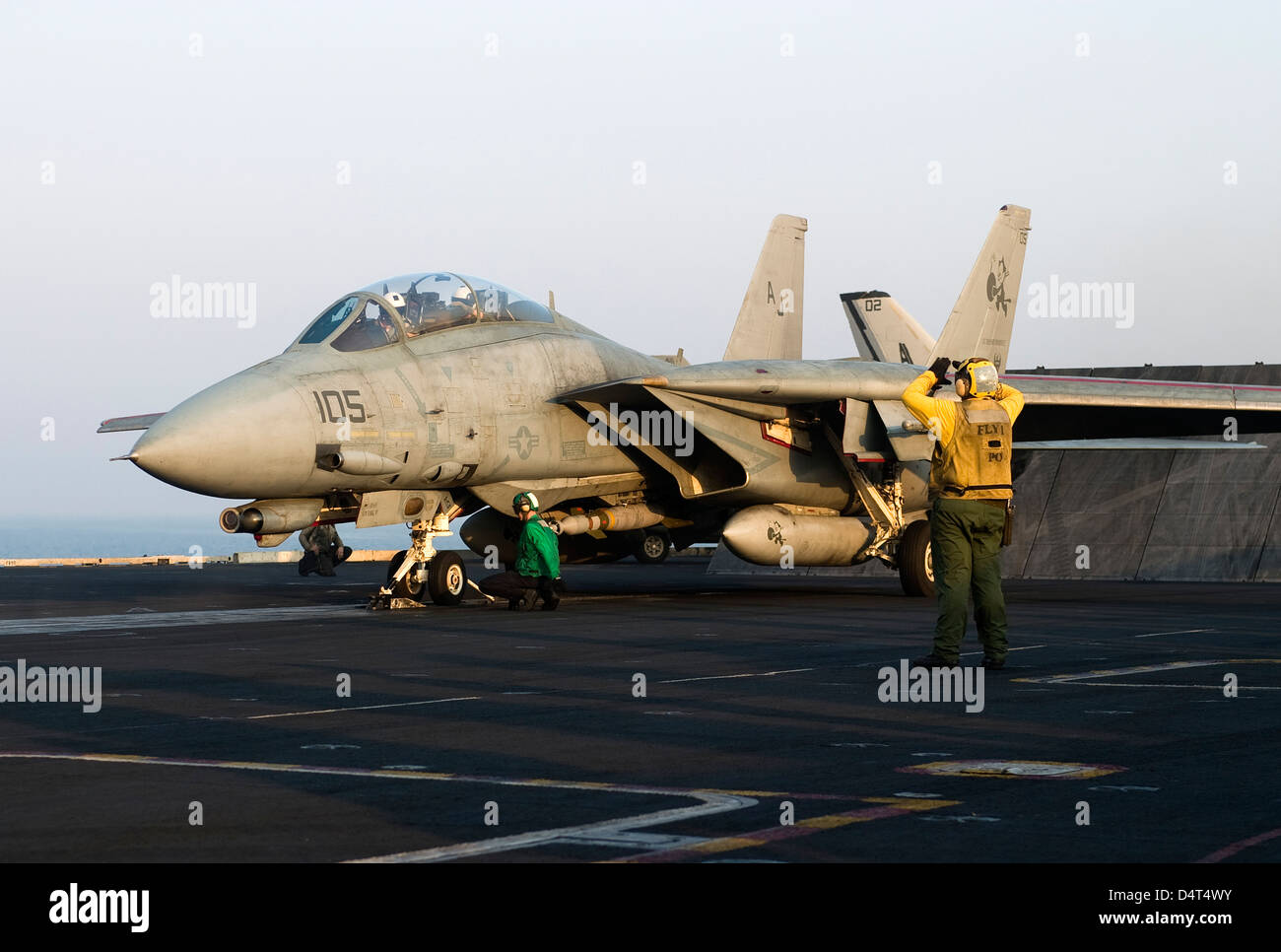 An F-14D Tomcat in launch position on the flight deck of USS Theodore ...