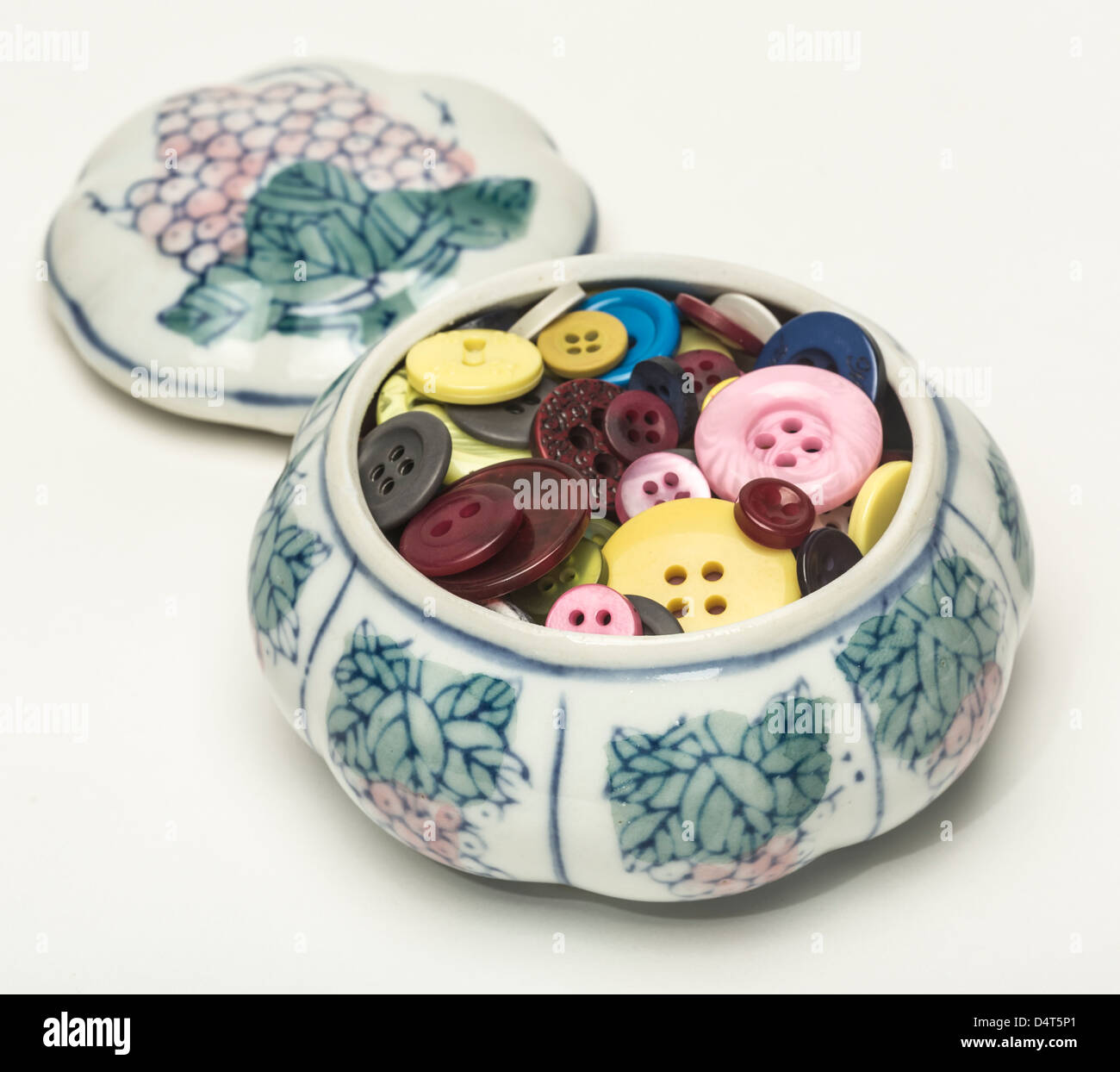 decorative glass container of clothing buttons Stock Photo - Alamy