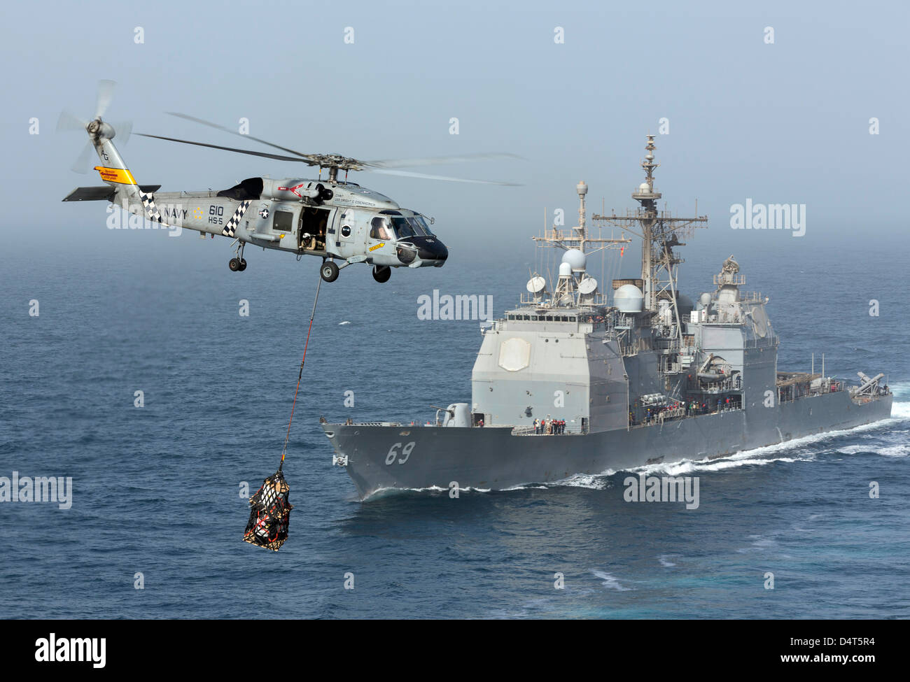 A SH-60J Seahawk flys by USS Vicksburg during a vertical replenishment ...