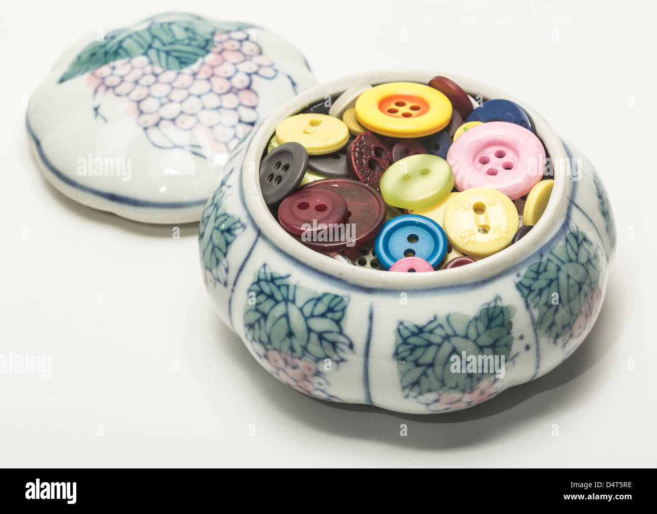 decorative glass container of clothing buttons Stock Photo - Alamy