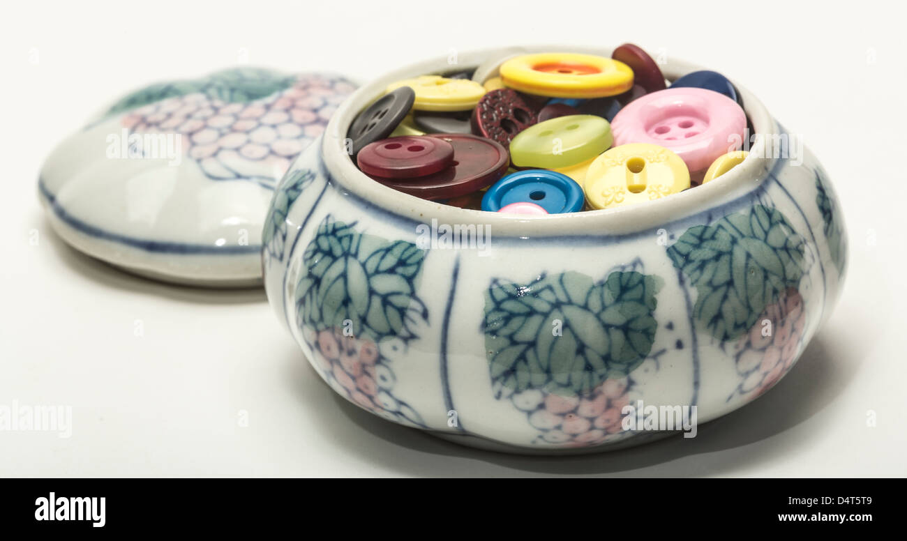 decorative glass container of clothing buttons Stock Photo - Alamy