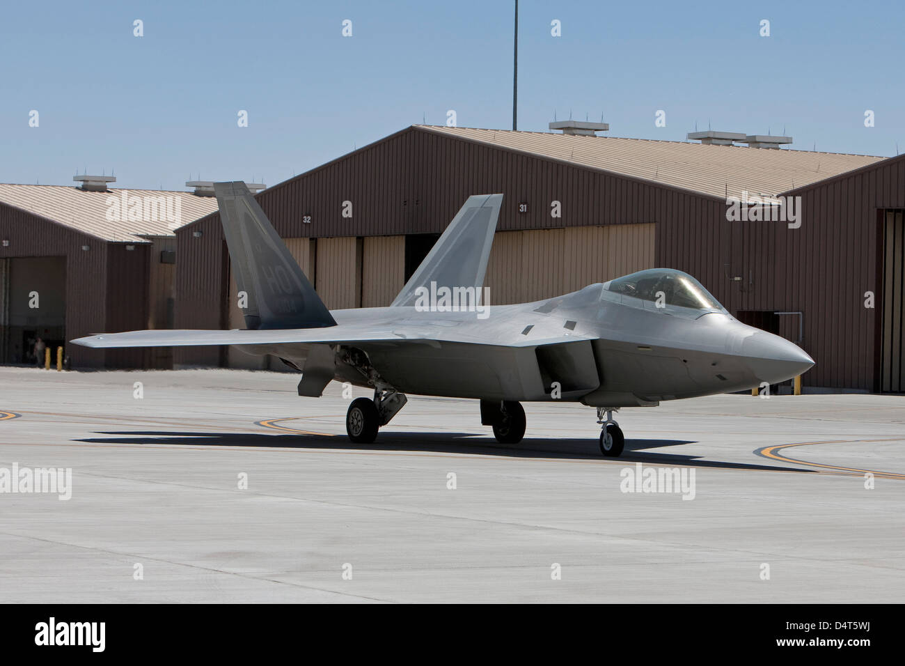 An F-22 Raptor taxi's to the runway for a training mission out of ...