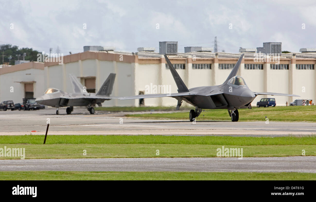 Two F-22 Raptor's taxi to the end of runway at Kadena Air Base, Japan ...