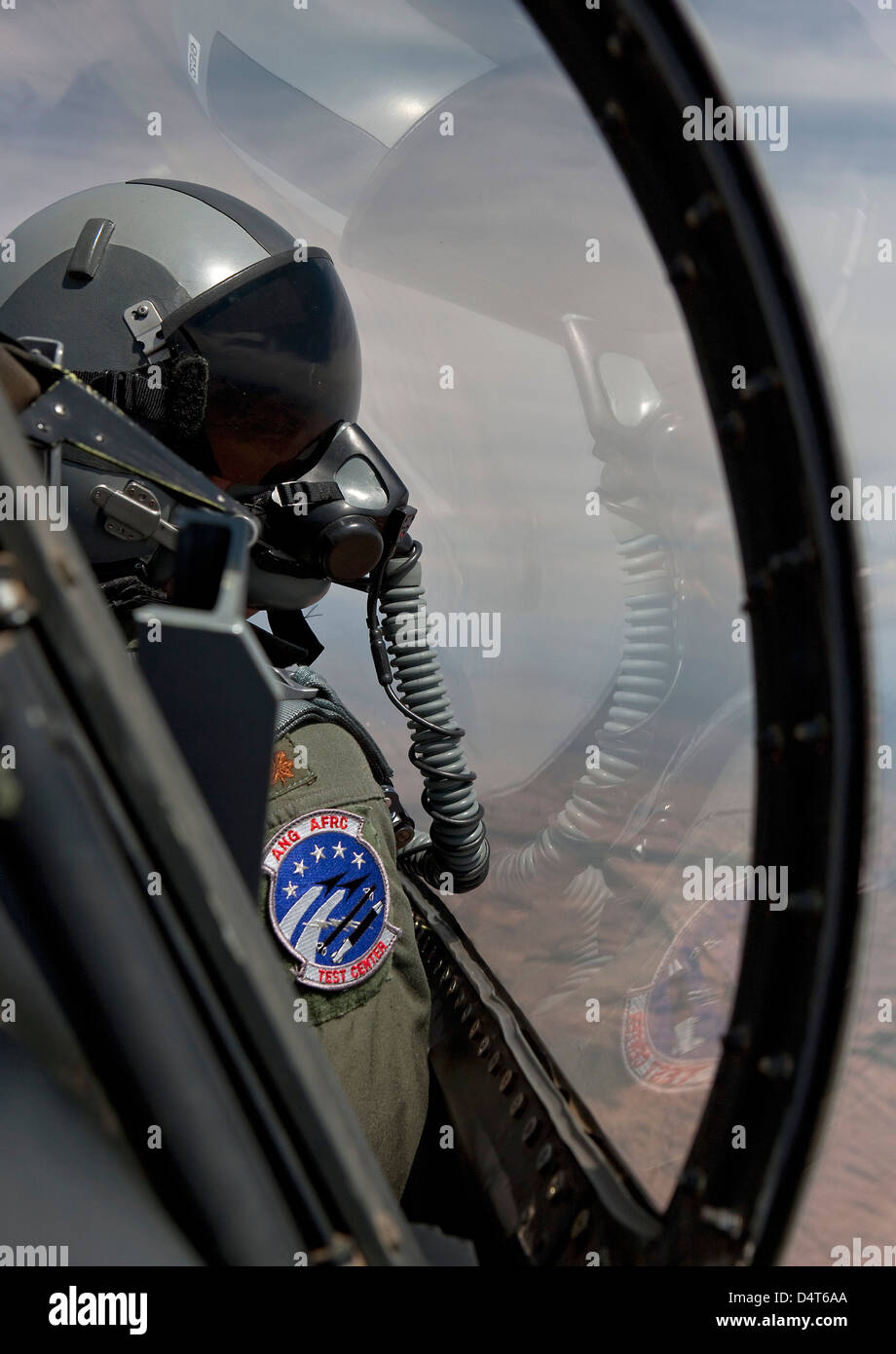 An F-16 pilot checks the position of his wingman during a test mission ...