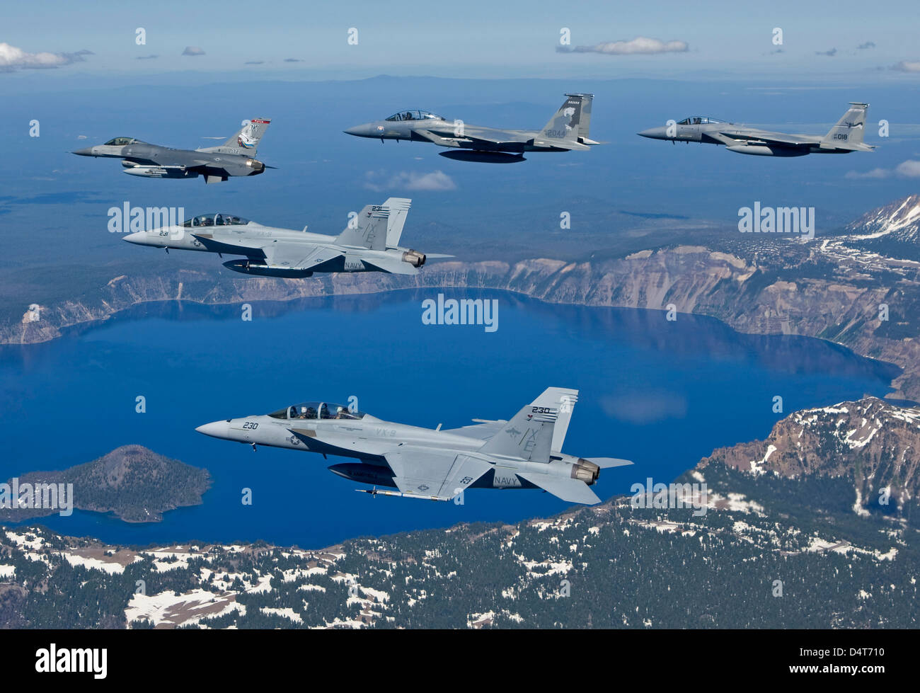 A five ship aircraft formation flies over Crater Lake, Oregon Stock ...
