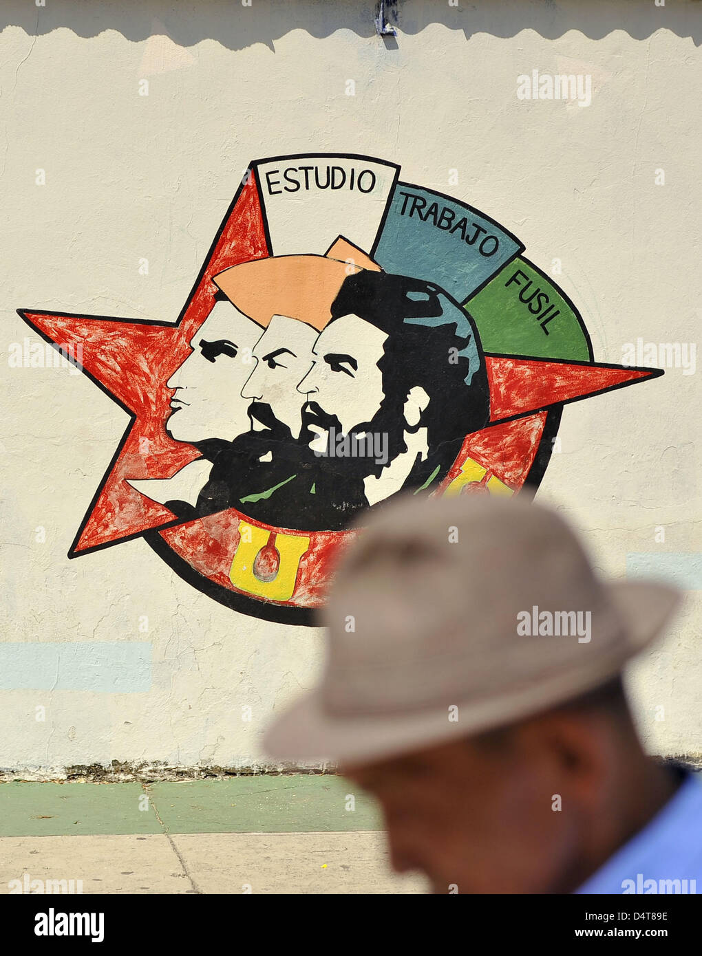 March 11, 2013 - Havana, Cuba - A Cuban man passes a wall mural ...