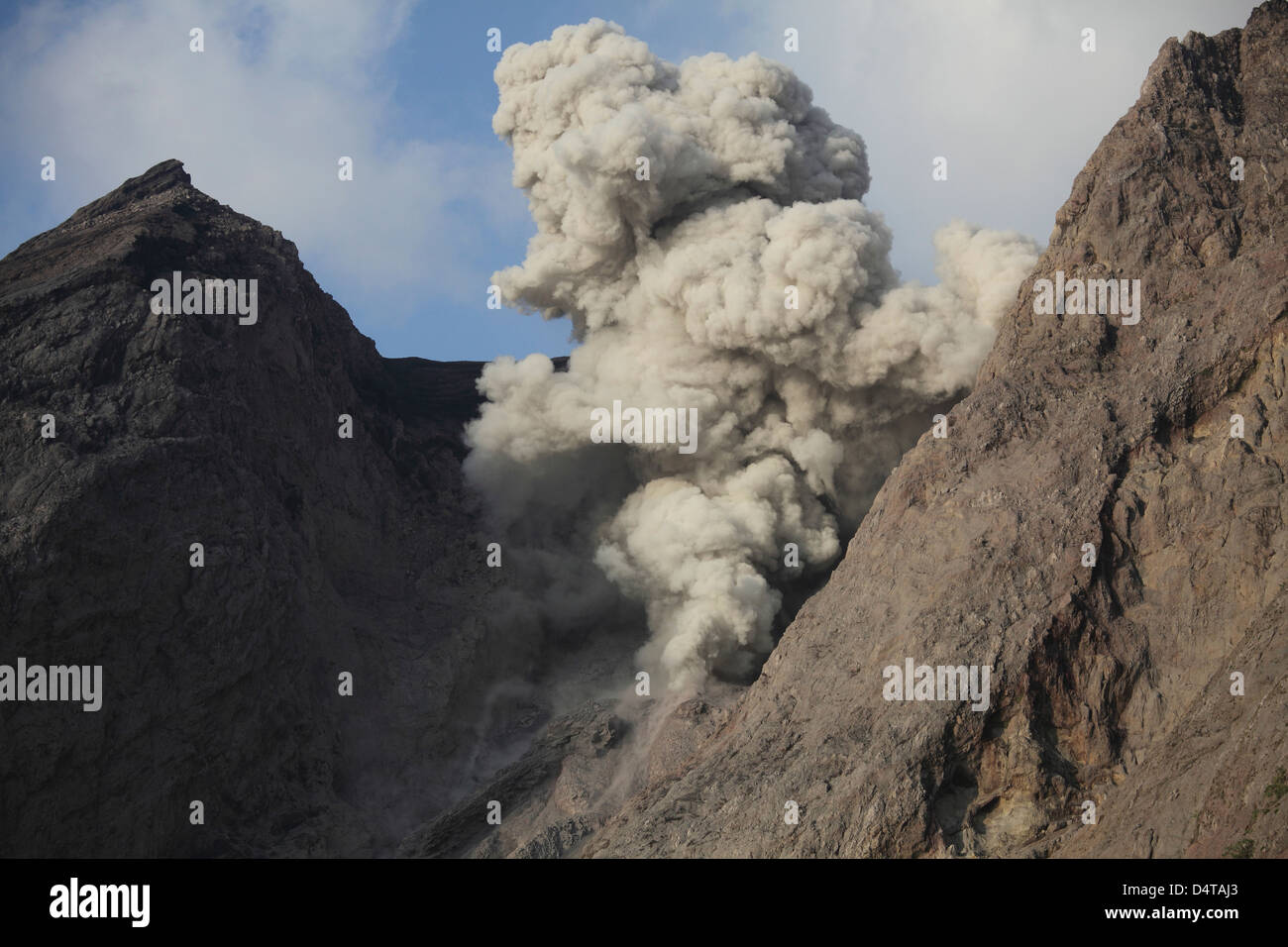 Ash cloud rises from crater of Batu Tara volcano, Indonesia Stock Photo ...