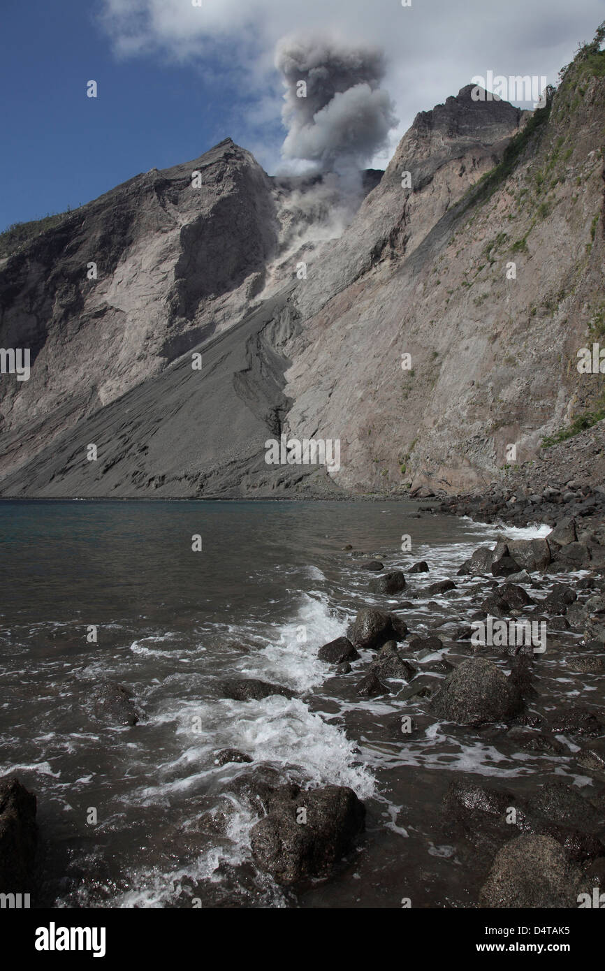 Ash cloud rises from crater of Batu Tara volcano, Indonesia Stock Photo ...