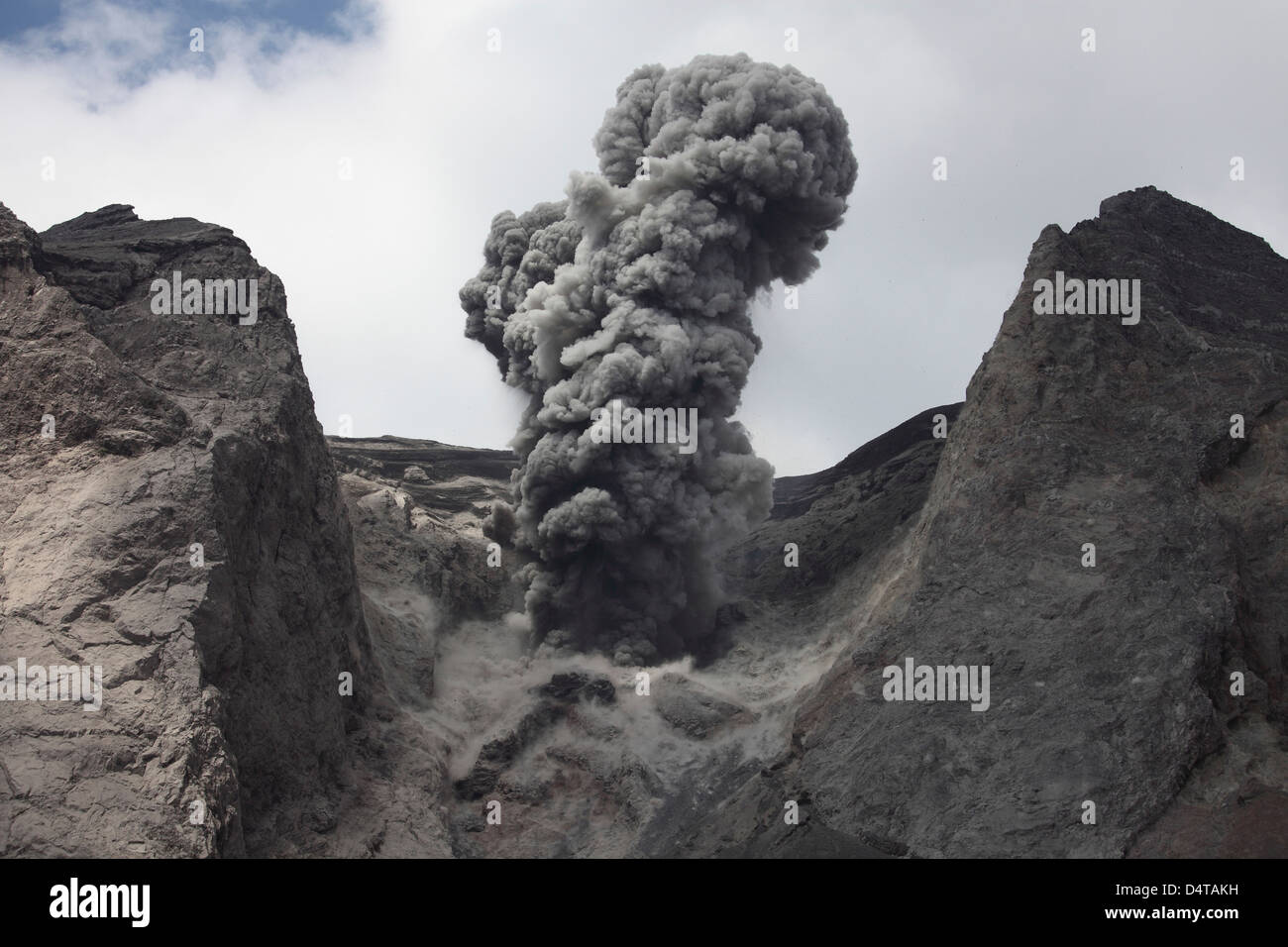 Ash cloud rises from crater of Batu Tara volcano, Indonesia Stock Photo ...