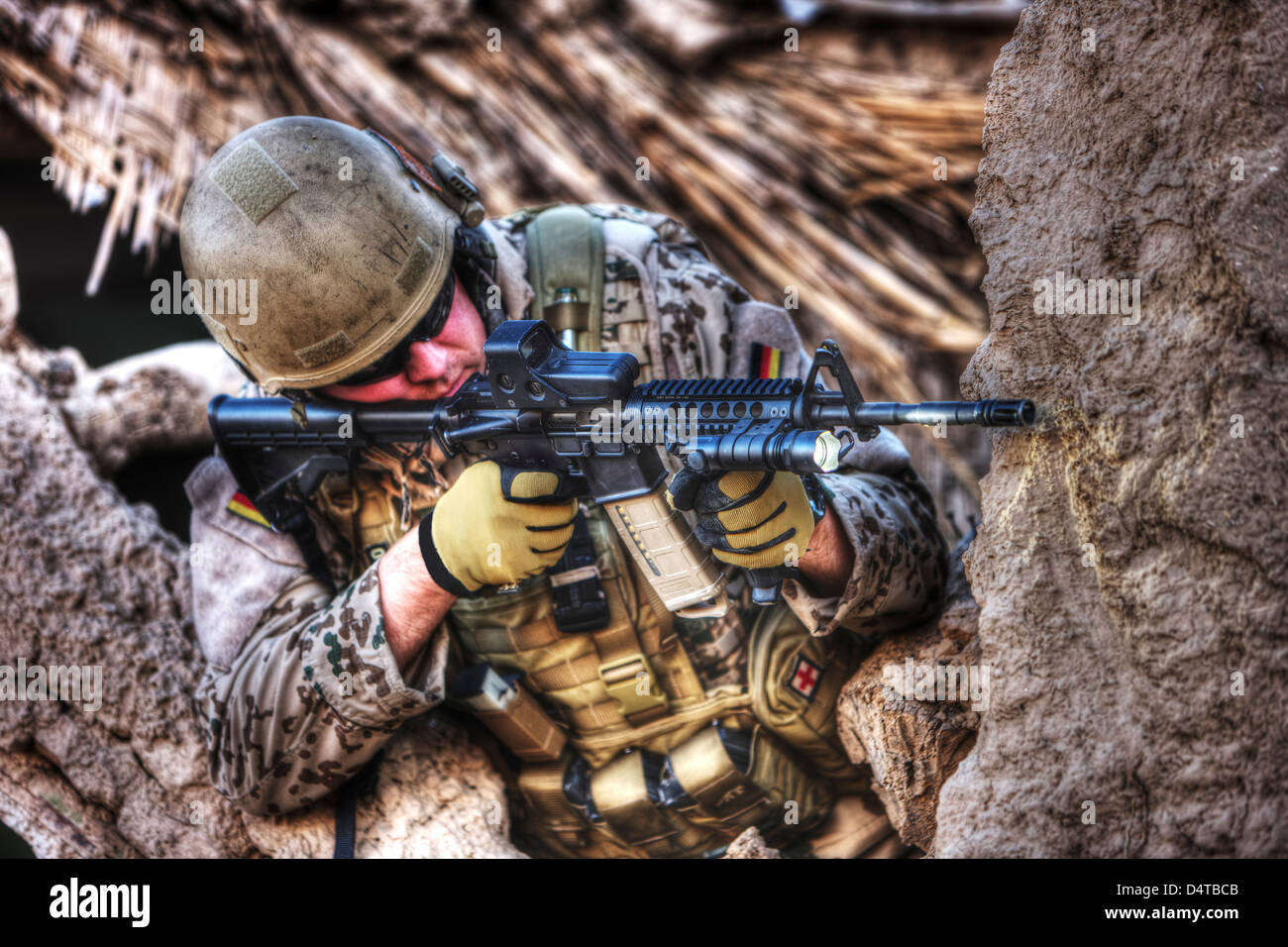 High Dynamic Range image of a German Army soldier armed with a M4 carbine assault rifle in the ...