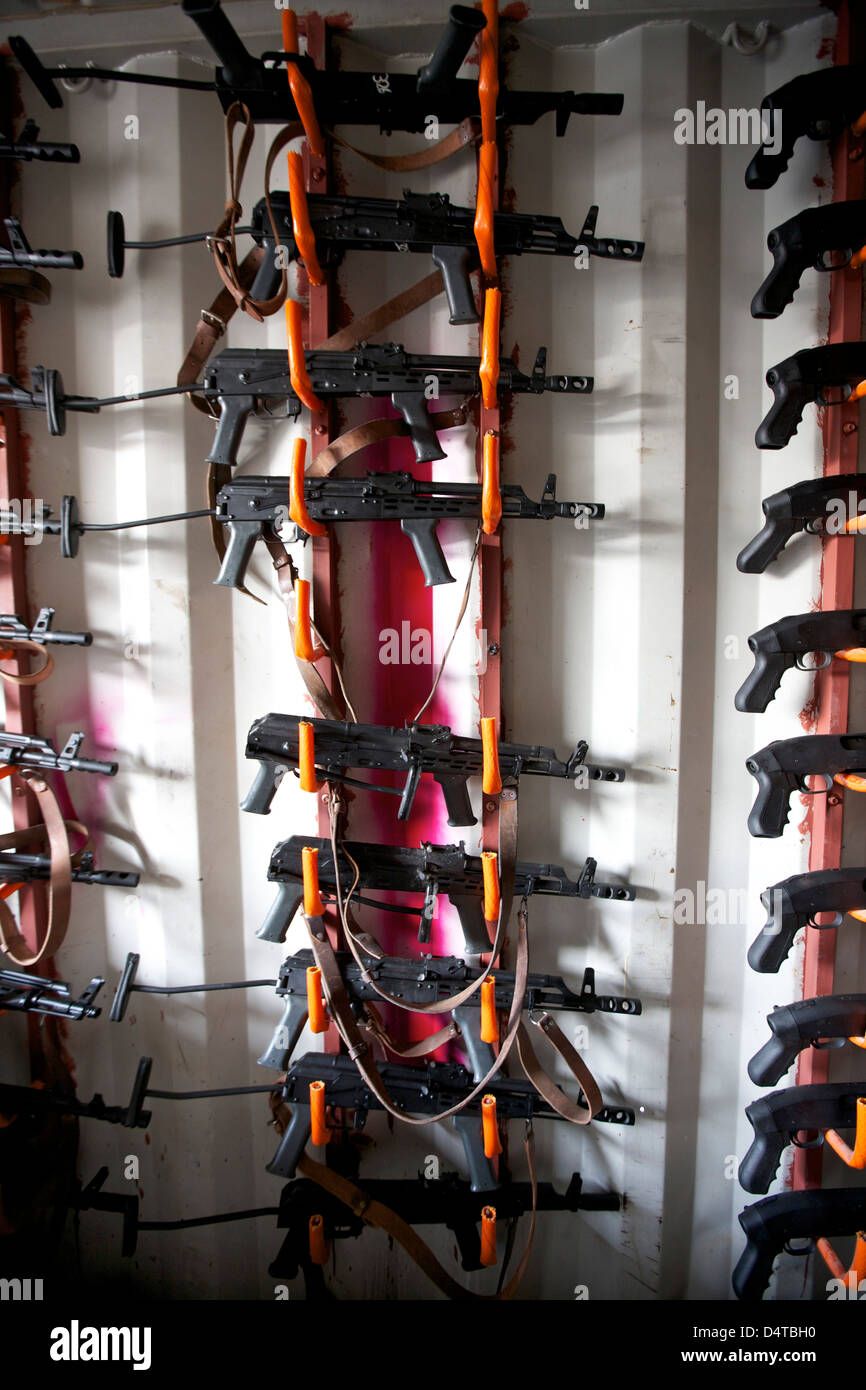 AKM assault rifles lined up on the wall in the armory Stock Photo - Alamy