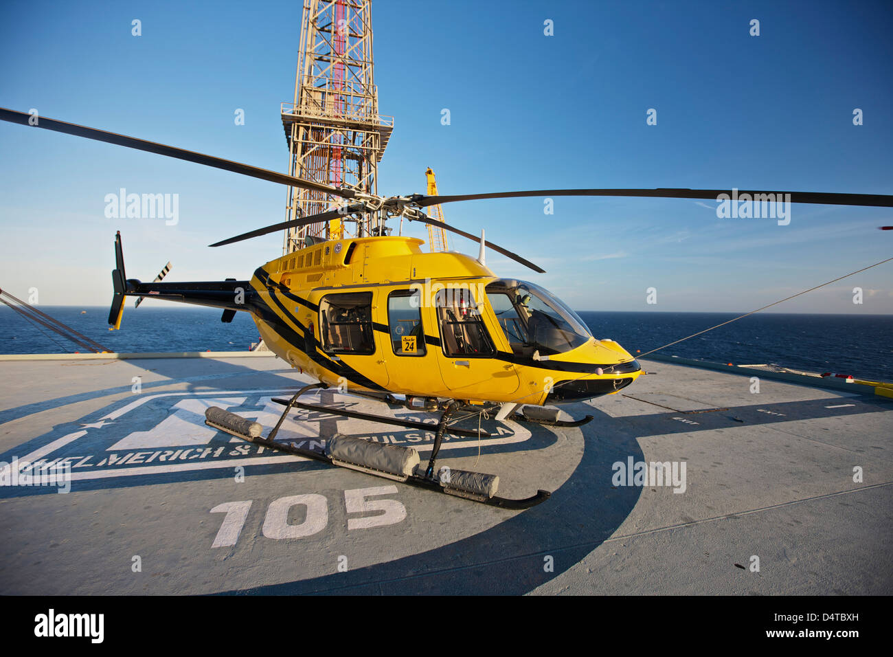 A Bell 407 utility helicopter on the helipad of an oil rig Stock Photo ...